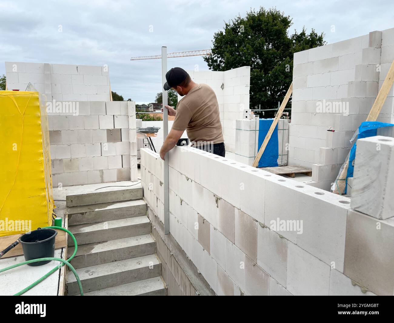 Construction worker building house walls with concrete sand lime bricks ...