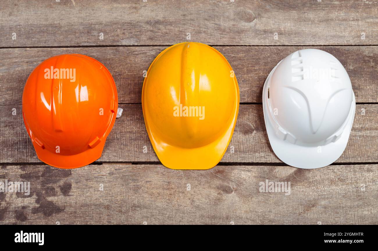 safety engineer helmet gear on top of brown wooden table background ...