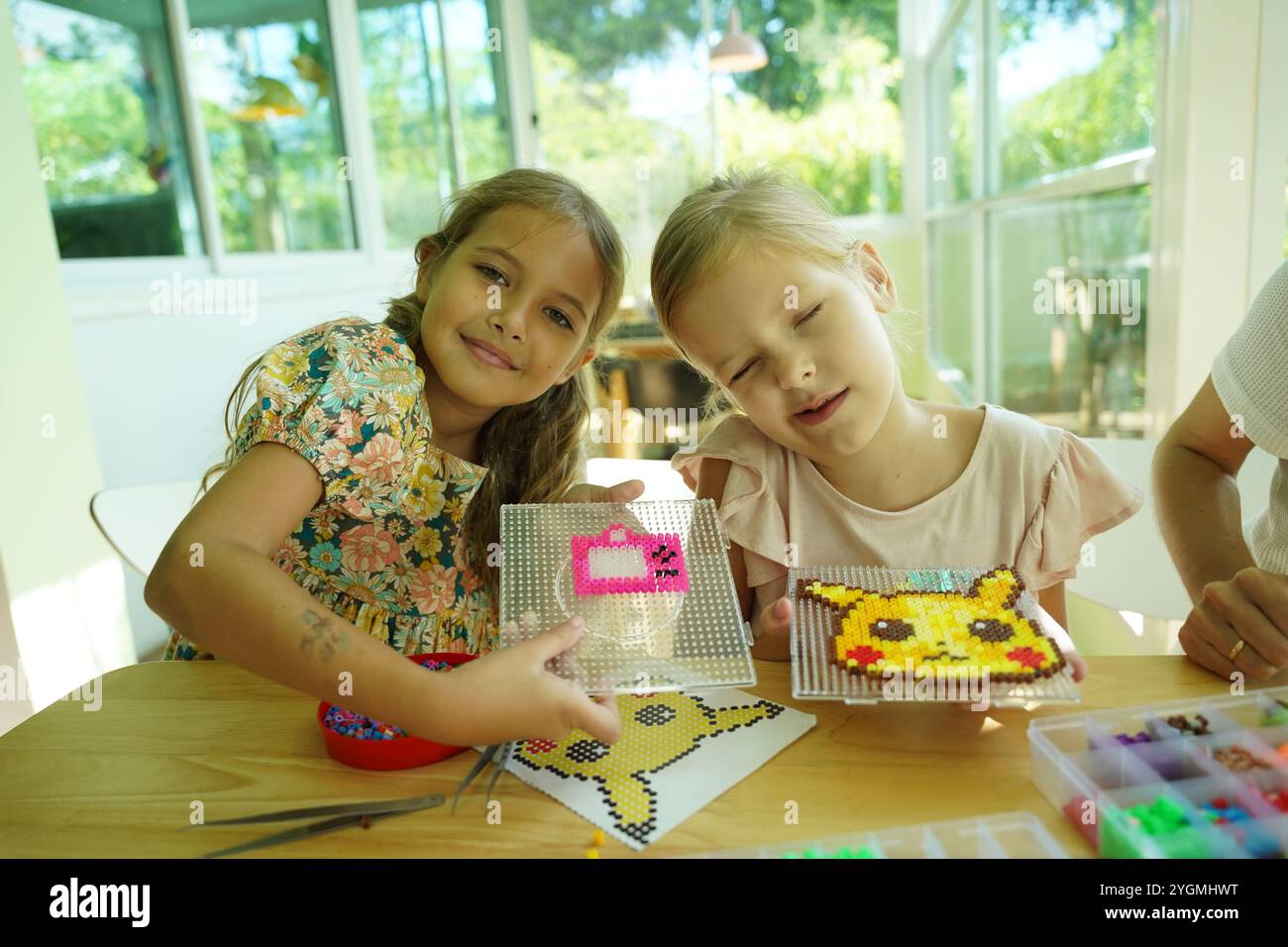 Teacher in workshop teched two girls how to assemble a thermo mosaic ...