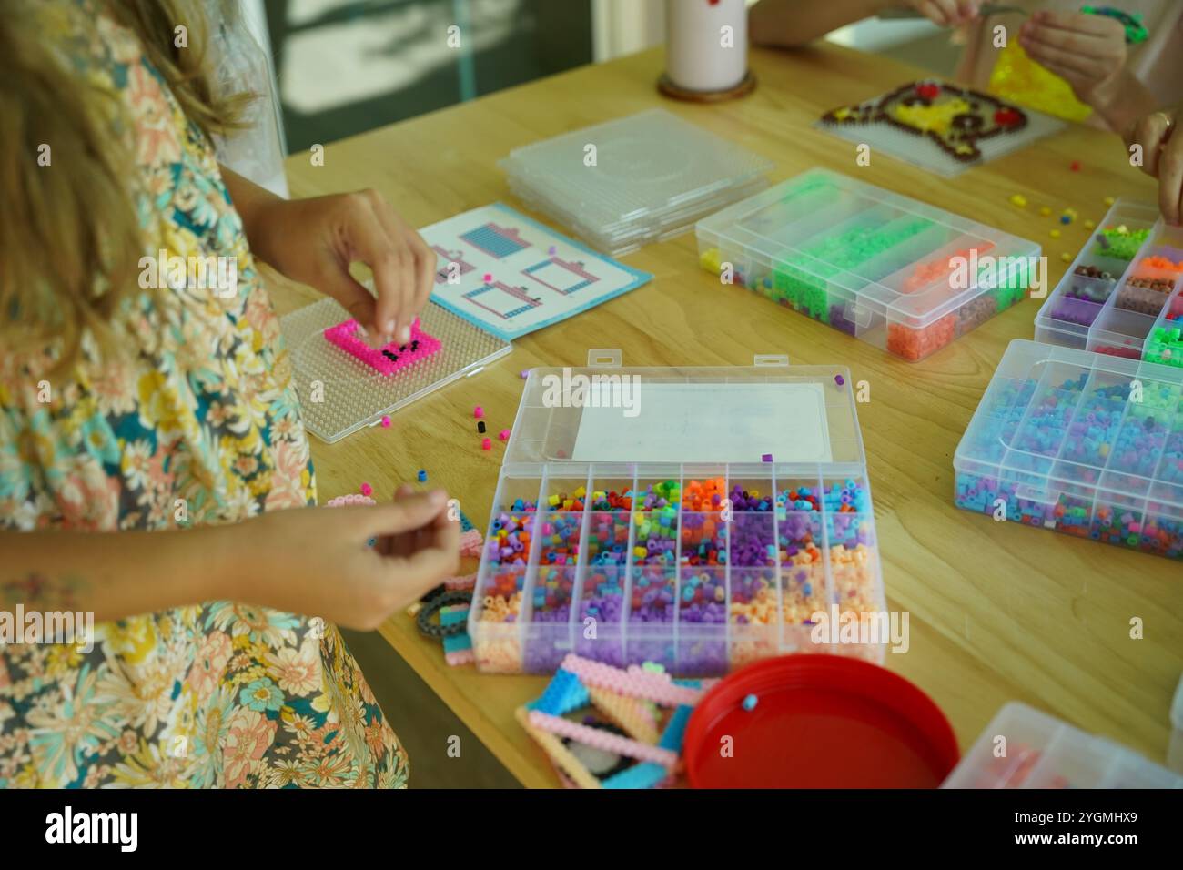 Teacher in workshop teched two girls how to assemble a thermo mosaic ...