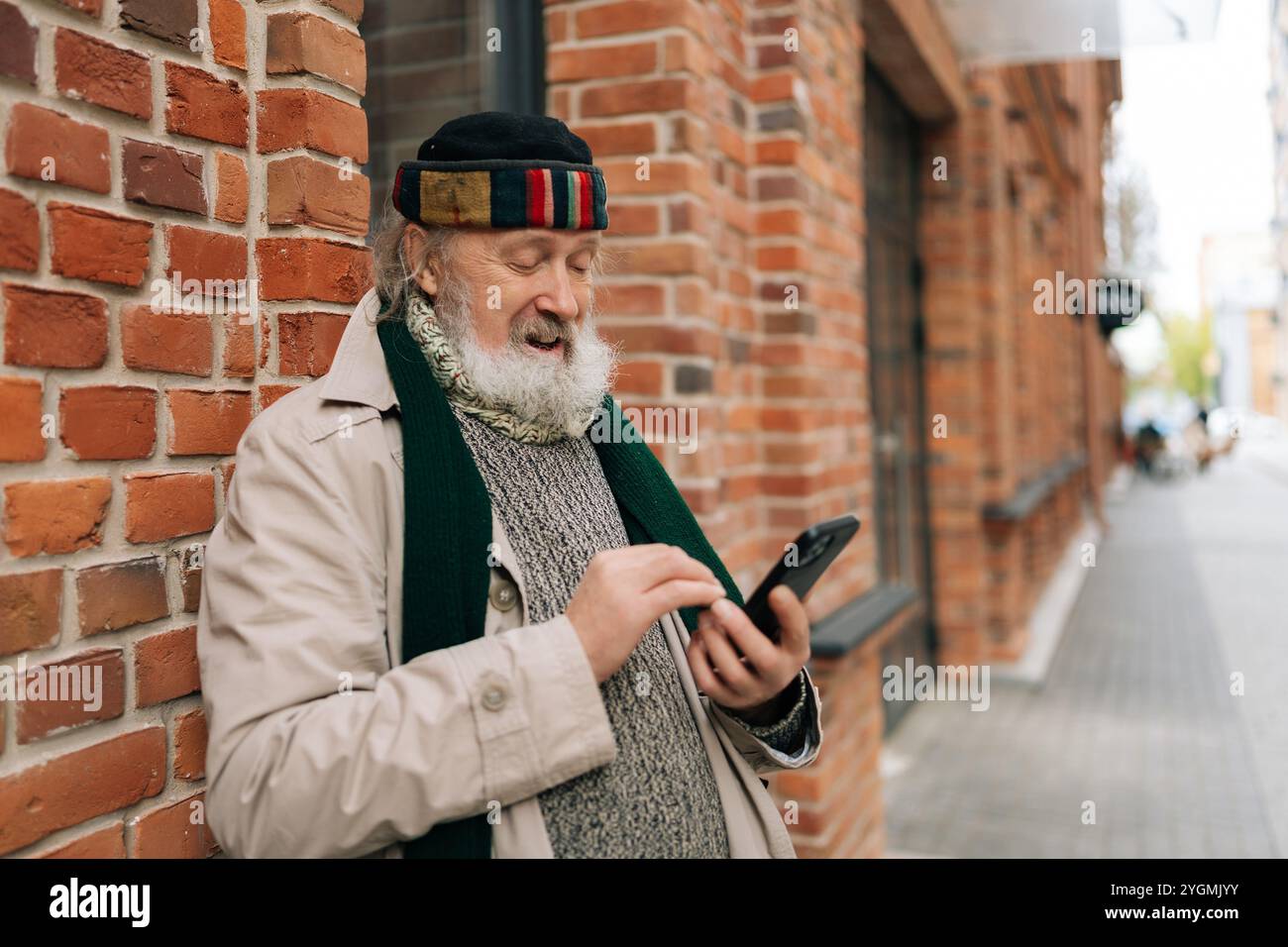 Medium shot portrait of aged homeless man looking surprised using ...