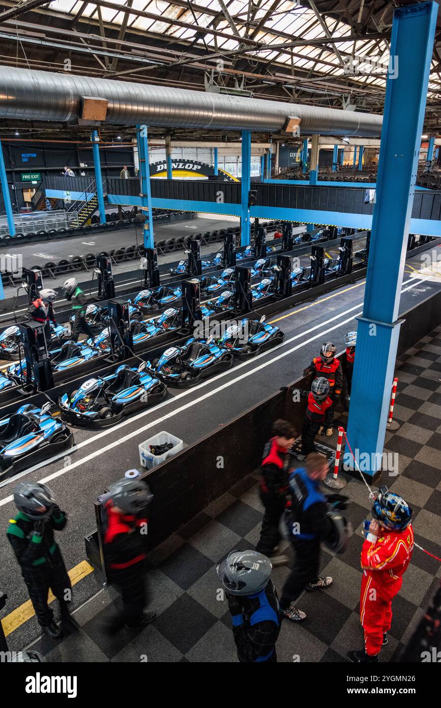 Drivers waiting to race while Electric Go karts are lined up and ...