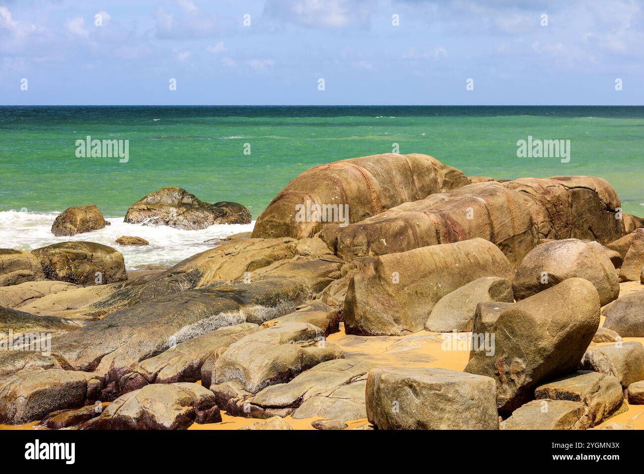 Empty tropical beach with big stones, view to yellow sand and blue sea ...