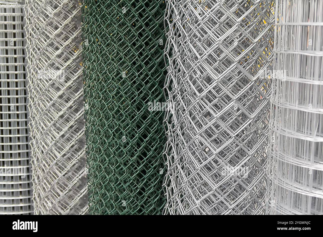 Rolled chain-link fence. Metal mesh netting rolled into rolls. Industry ...