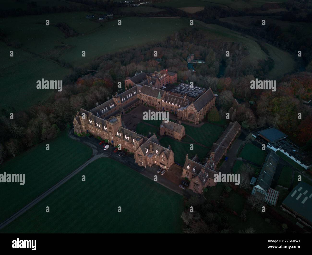 Aerial view of a historic, sprawling Gothic-style estate surrounded by ...