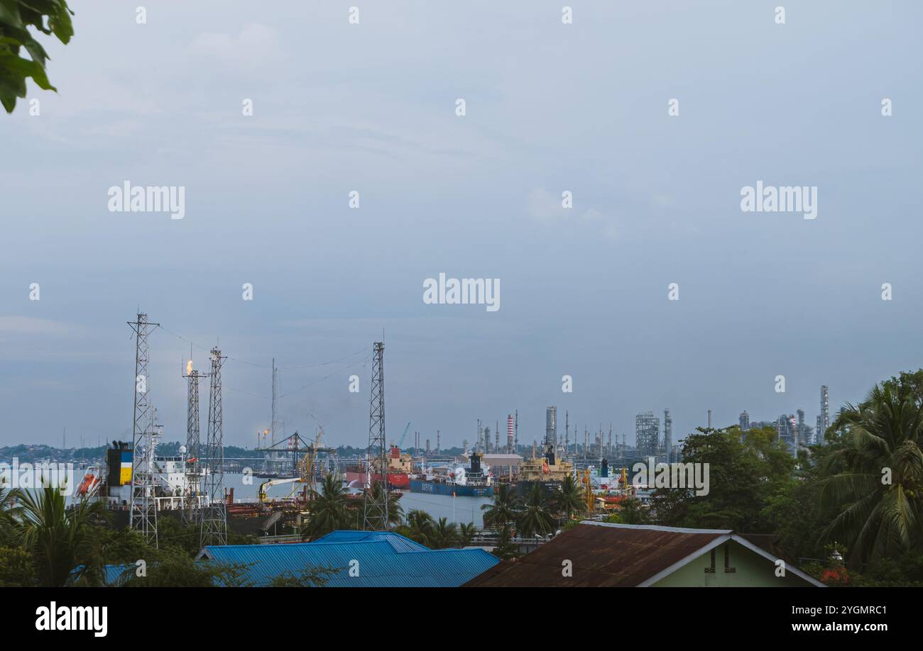 Photo of an oil refinery in Balikpapan city seen from above a housing ...
