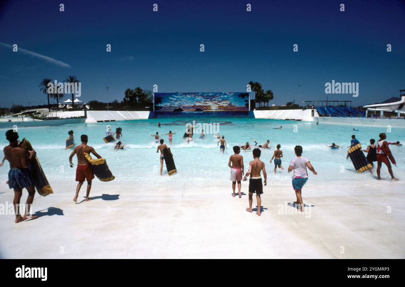 People enjoy the wave-making machine at Big Surf water park in Phoenix ...