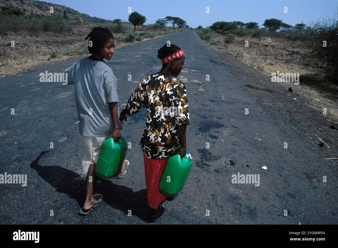 Women carrying water to their home near Shashemene, Ethiopia. Many ...