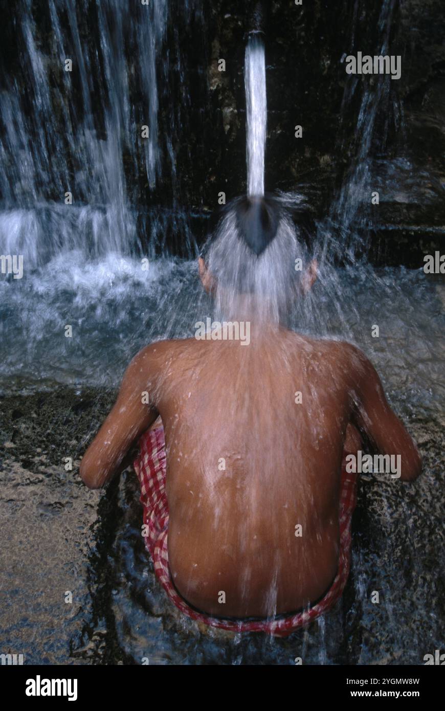 Rear of a boy bathing under a hand pump, Calcutta, India Stock Photo ...