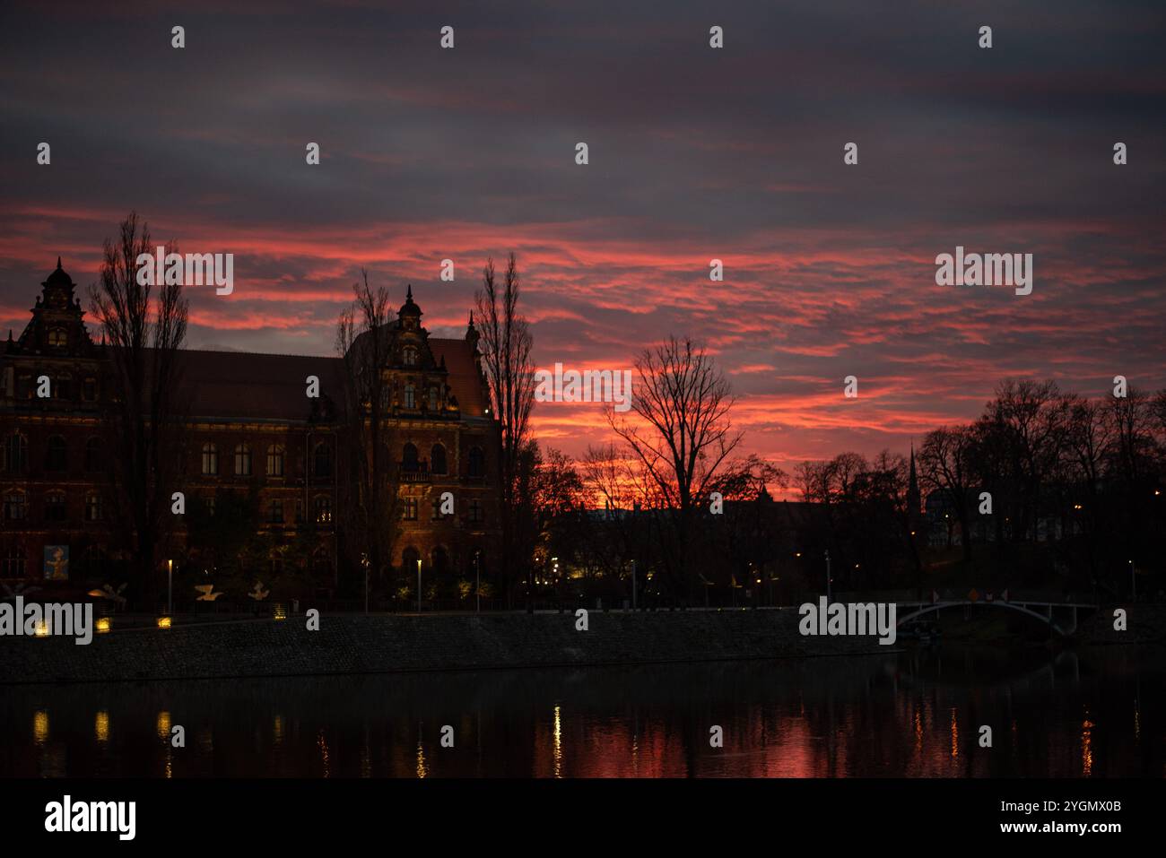 The incredible sunset sky above the National Museum in Wrocław casts a warm glow over the ...