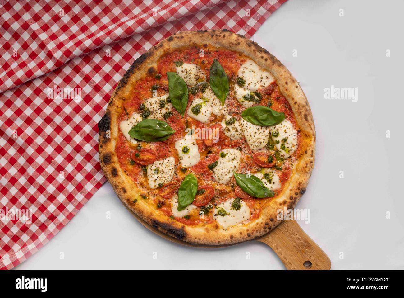 traditional Margherita pizza topped with fresh mozzarella, basil leaves, and a rich tomato sauce ...