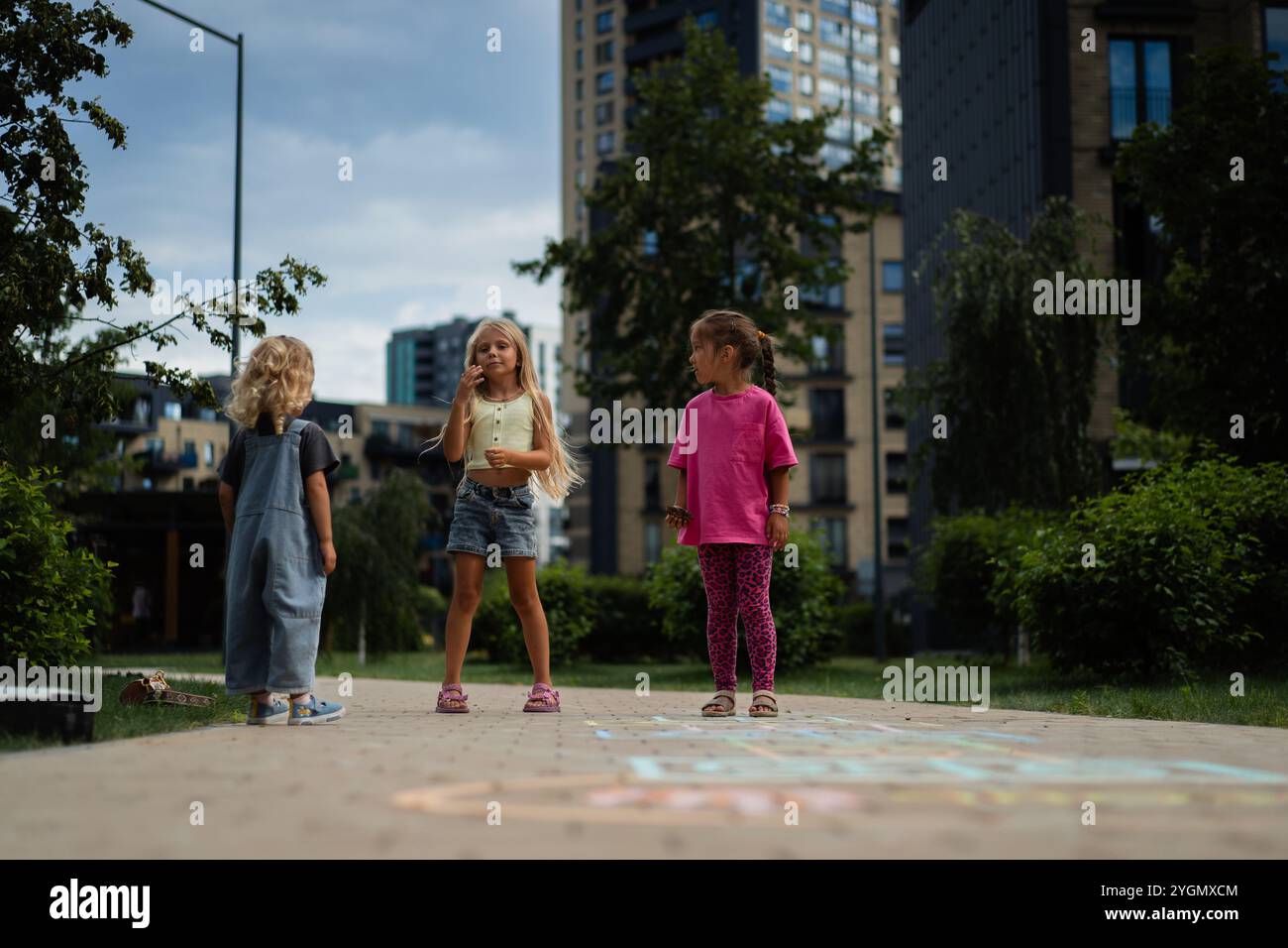 Girls playing hopscotch in the yard in the summer Stock Photo - Alamy