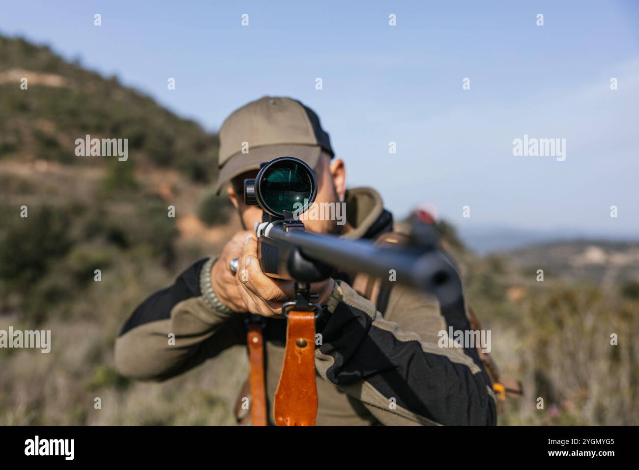 Hunter aiming with rifle scope in nature Stock Photo - Alamy