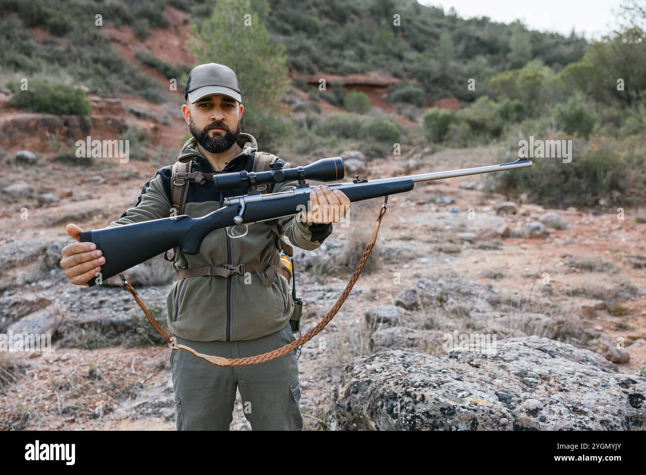 Hunter showing his rifle in nature during hunt Stock Photo - Alamy