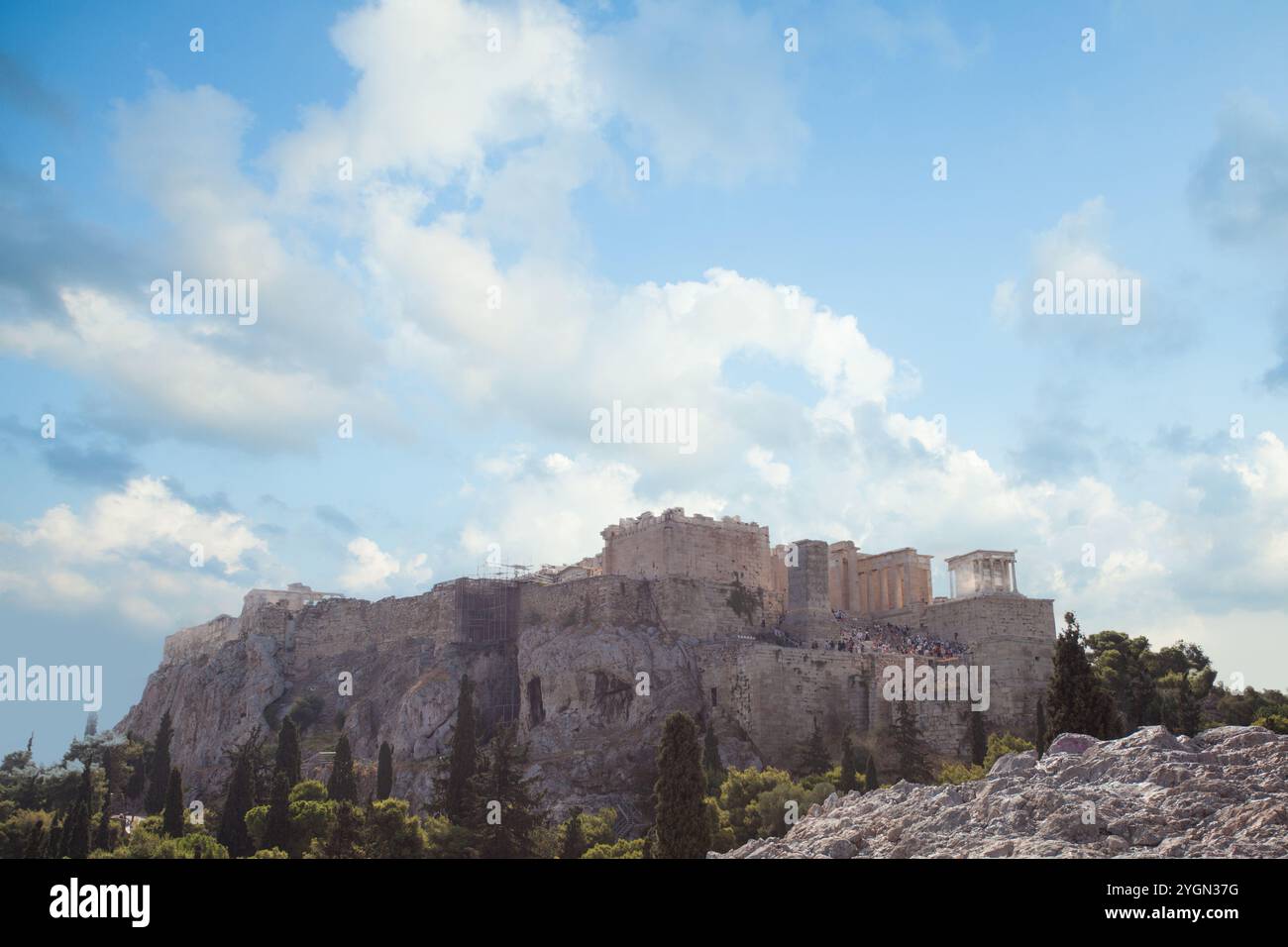 Pastel blue sky with white fluffy cloud and Acropolis hill. Athens ...