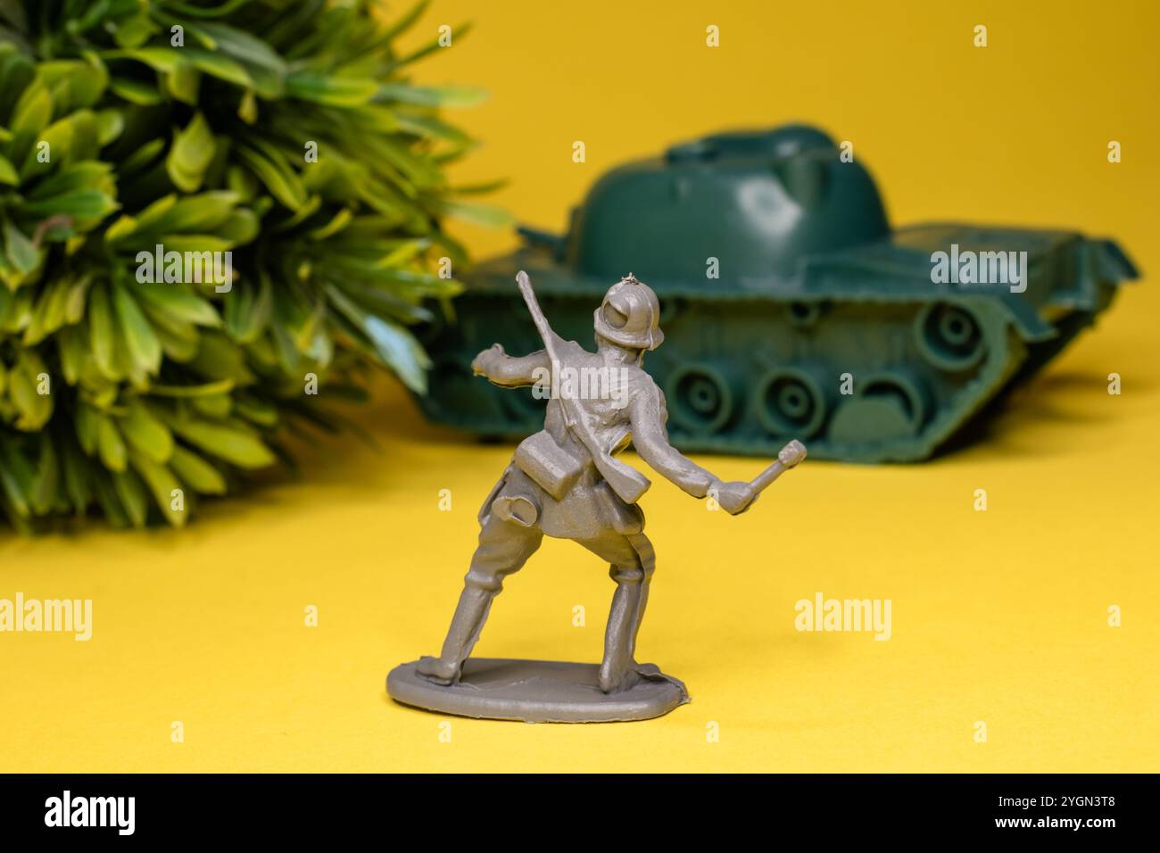 German toy soldier throwing stick hand grenade towards the tank on a ...