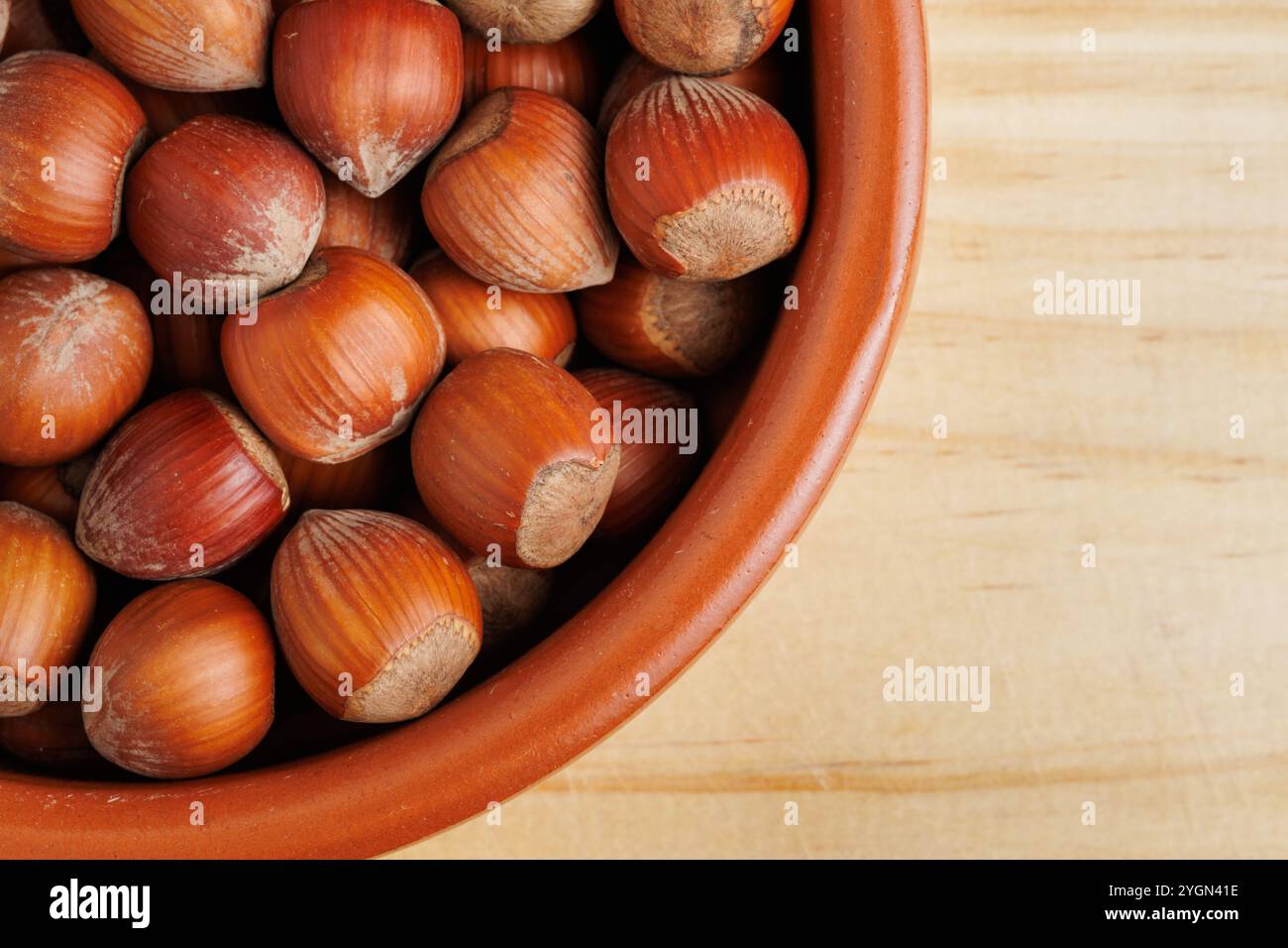 Group of hazelnuts with negative space in a clay container Stock Photo ...