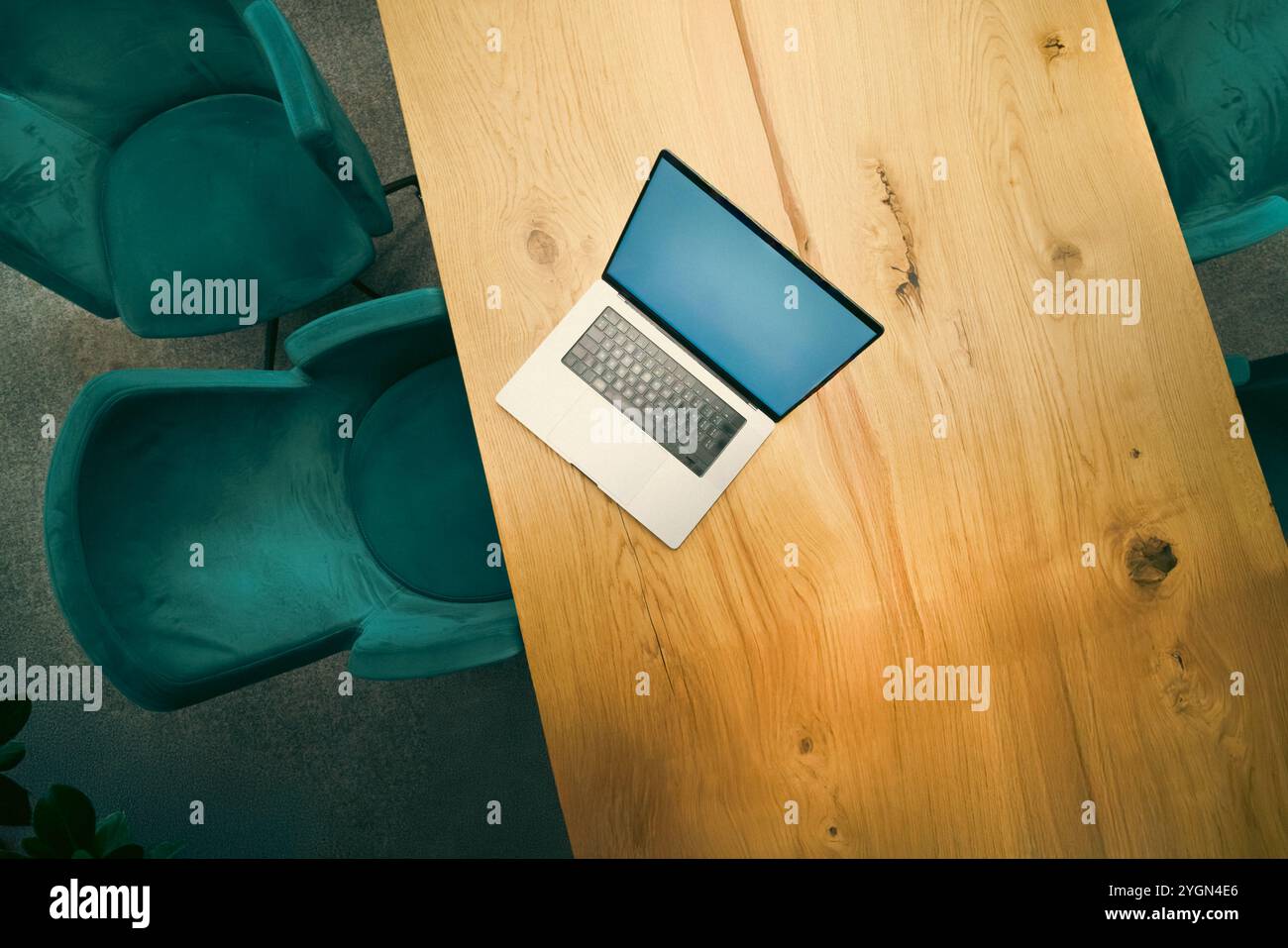 laptop on meeting room table armchair view from above business ...