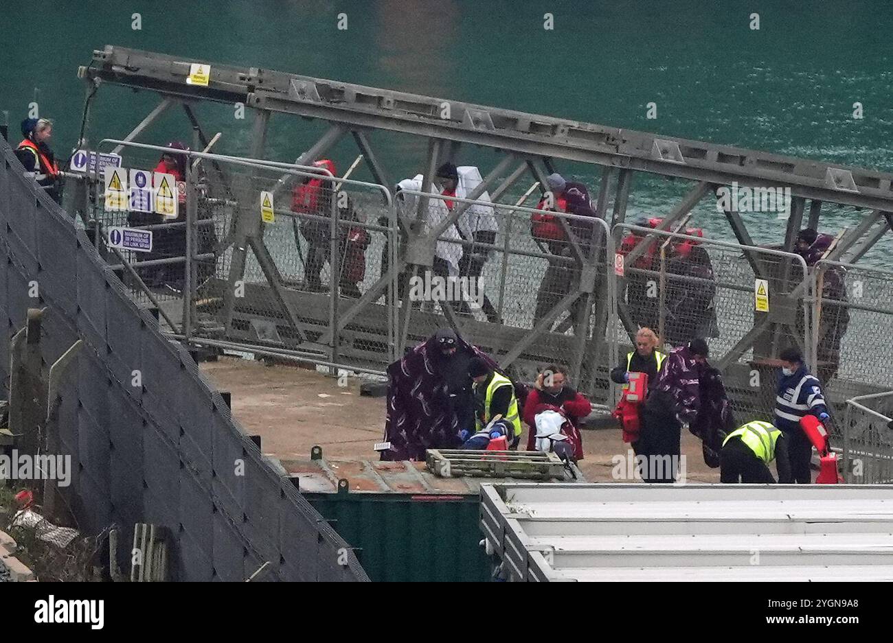 A group of people thought to be migrants are brought in to Dover, Kent ...