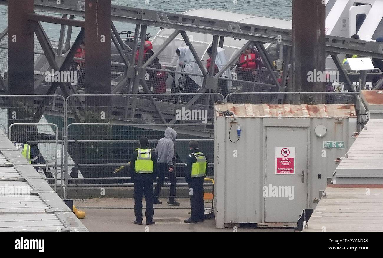 A group of people thought to be migrants are brought in to Dover, Kent ...