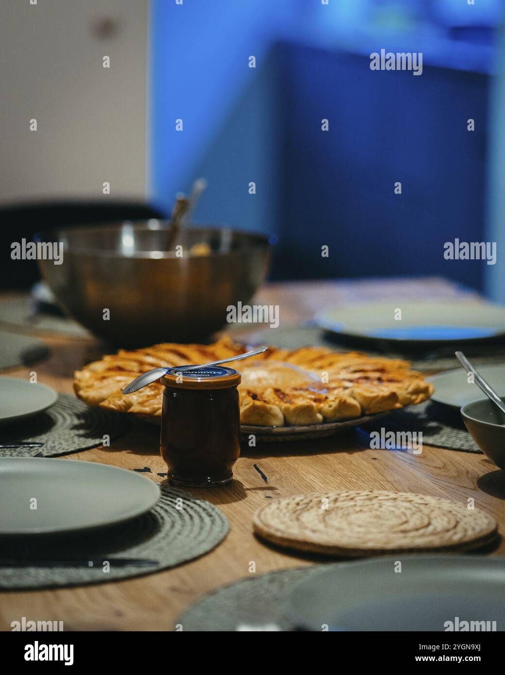 Table set for dinner including plates, cutlery, bowl, food, ketchup ...