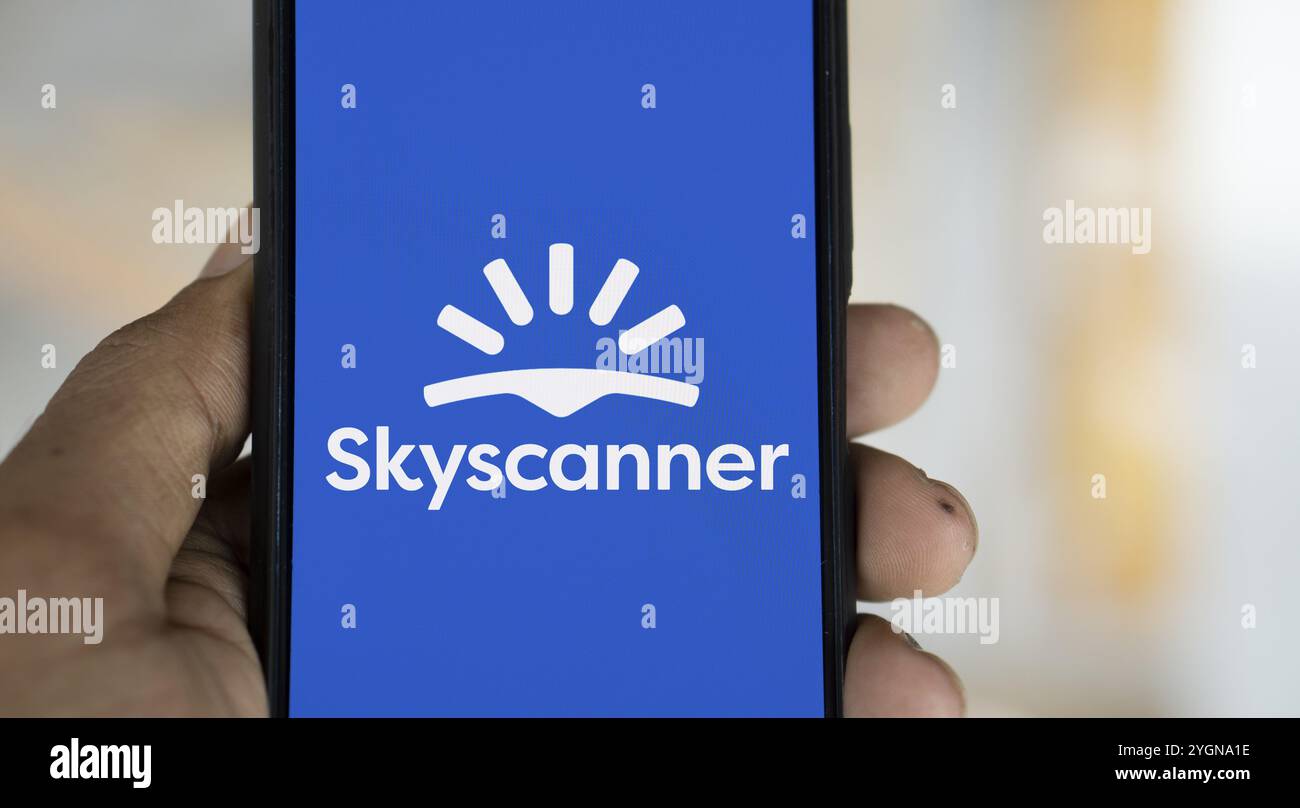 Skyscanner logo is displayed on smartphone. Skyscanner Ltd. is a search ...