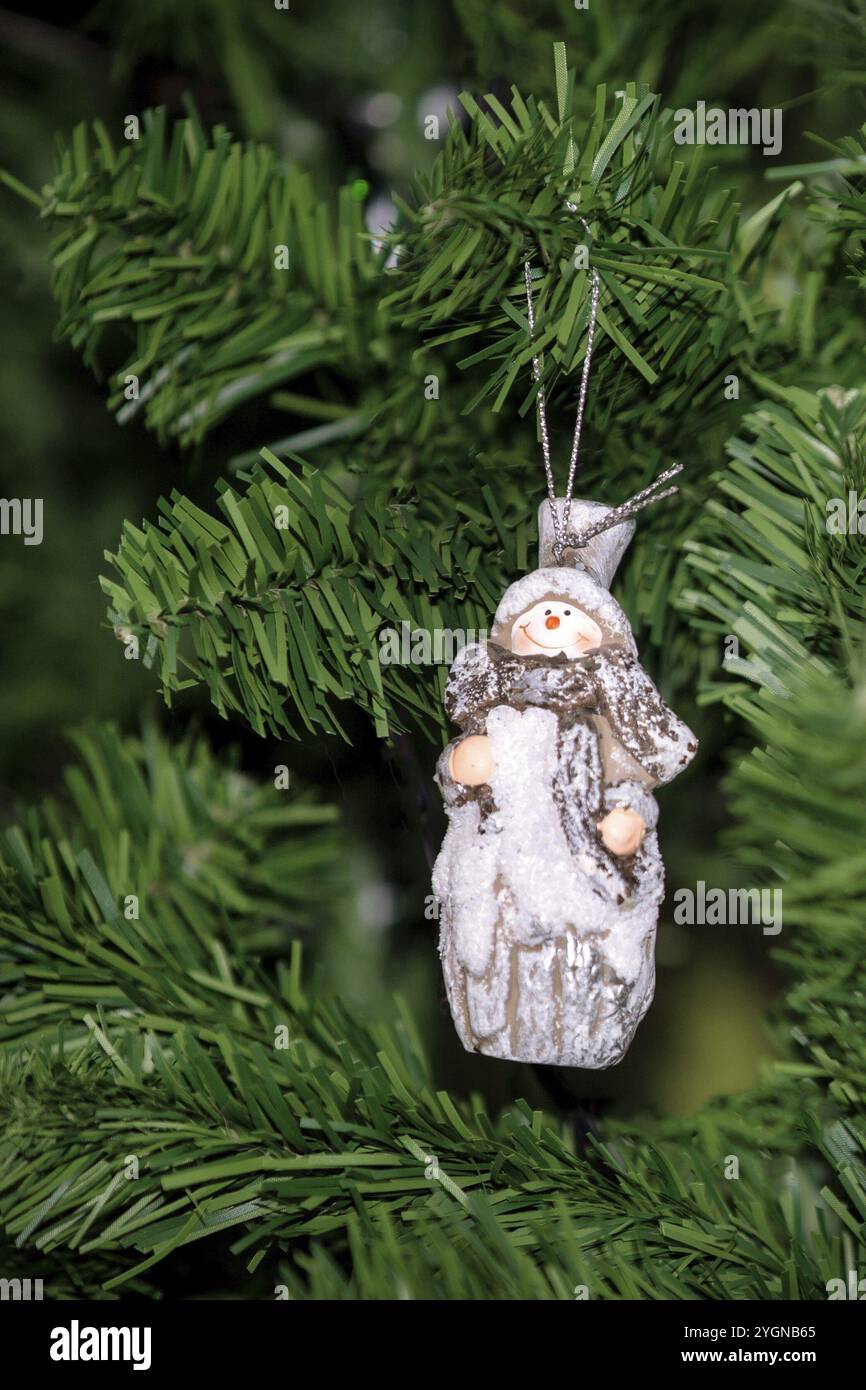 Snowman on decorated tree hi-res stock photography and images - Alamy