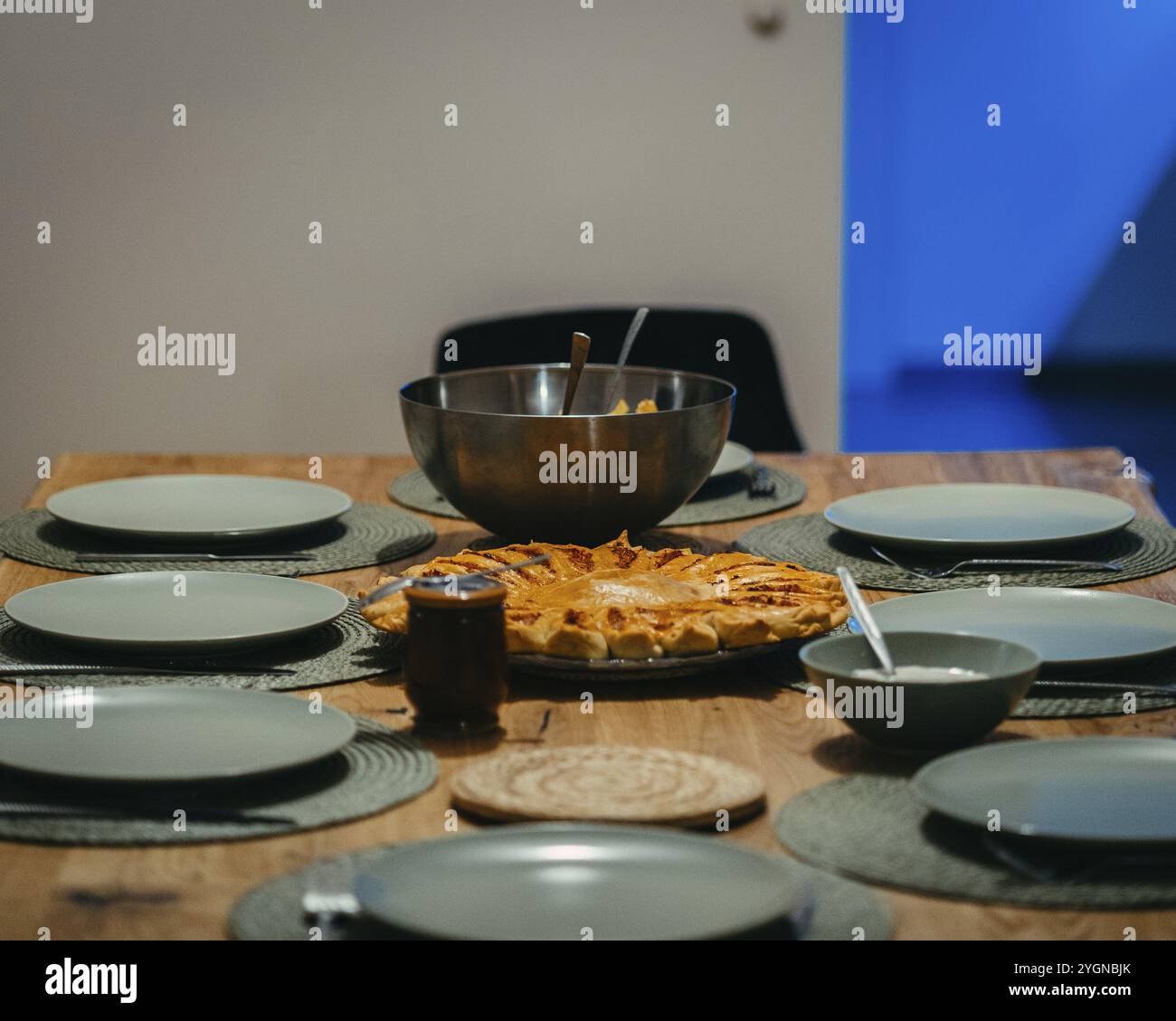 Table set for dinner including plates, cutlery, bowl, food, ketchup ...