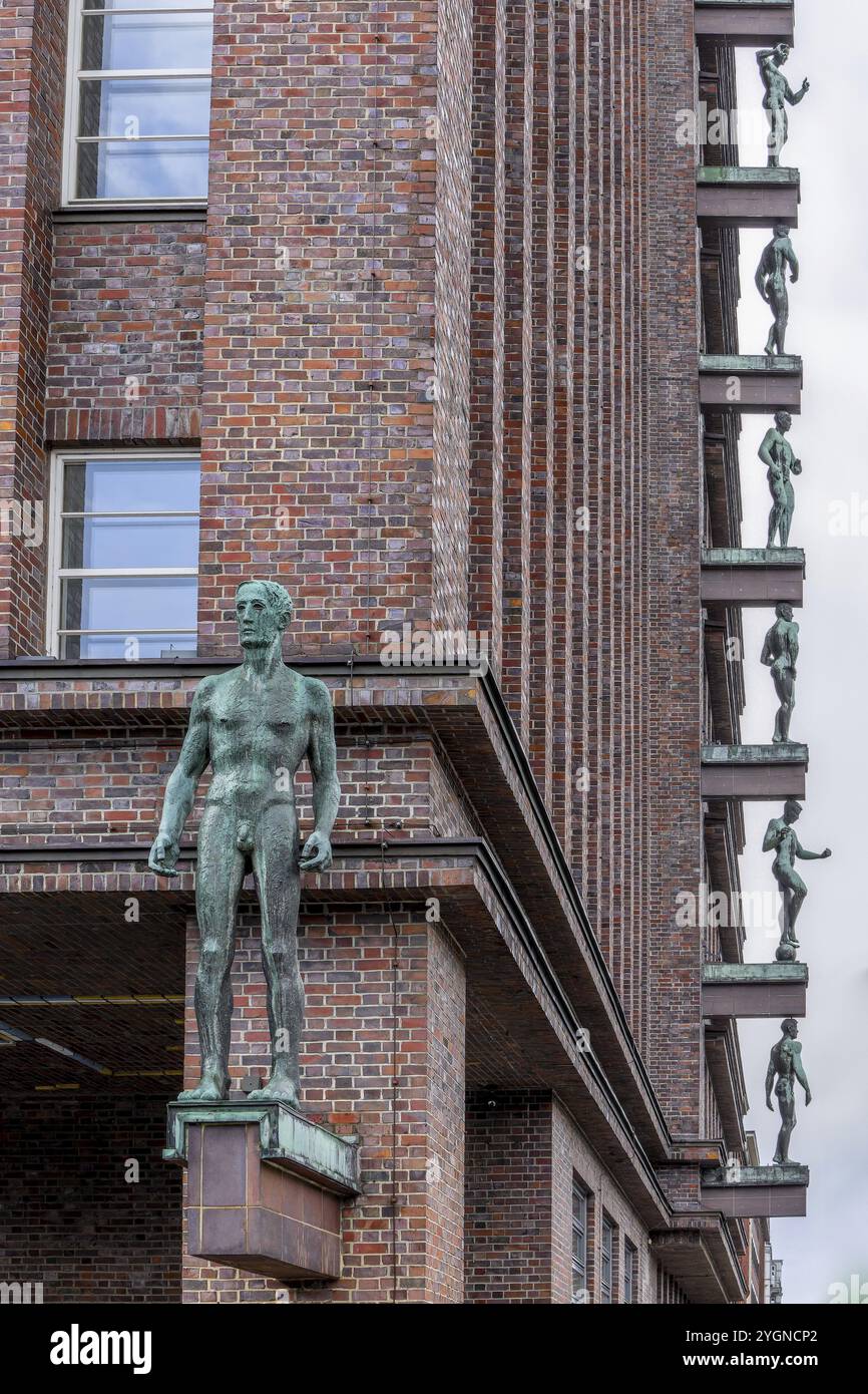 Male bronze sculpture on the corner of the brick facade and in the ...