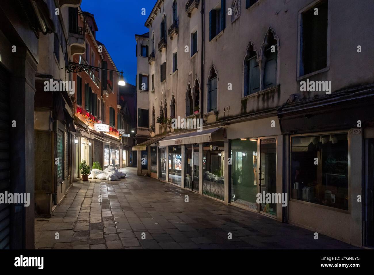 depopulated street of Venice early morning with garbage in trash backs ...