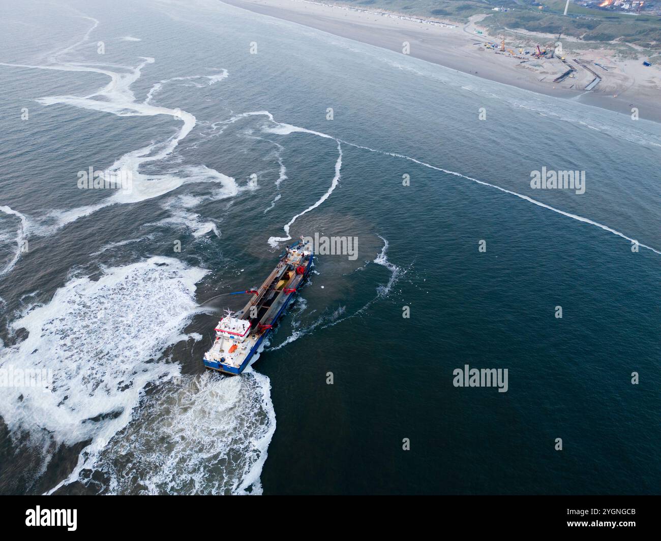 A dredger making preparations for the installation of a seacable from ...
