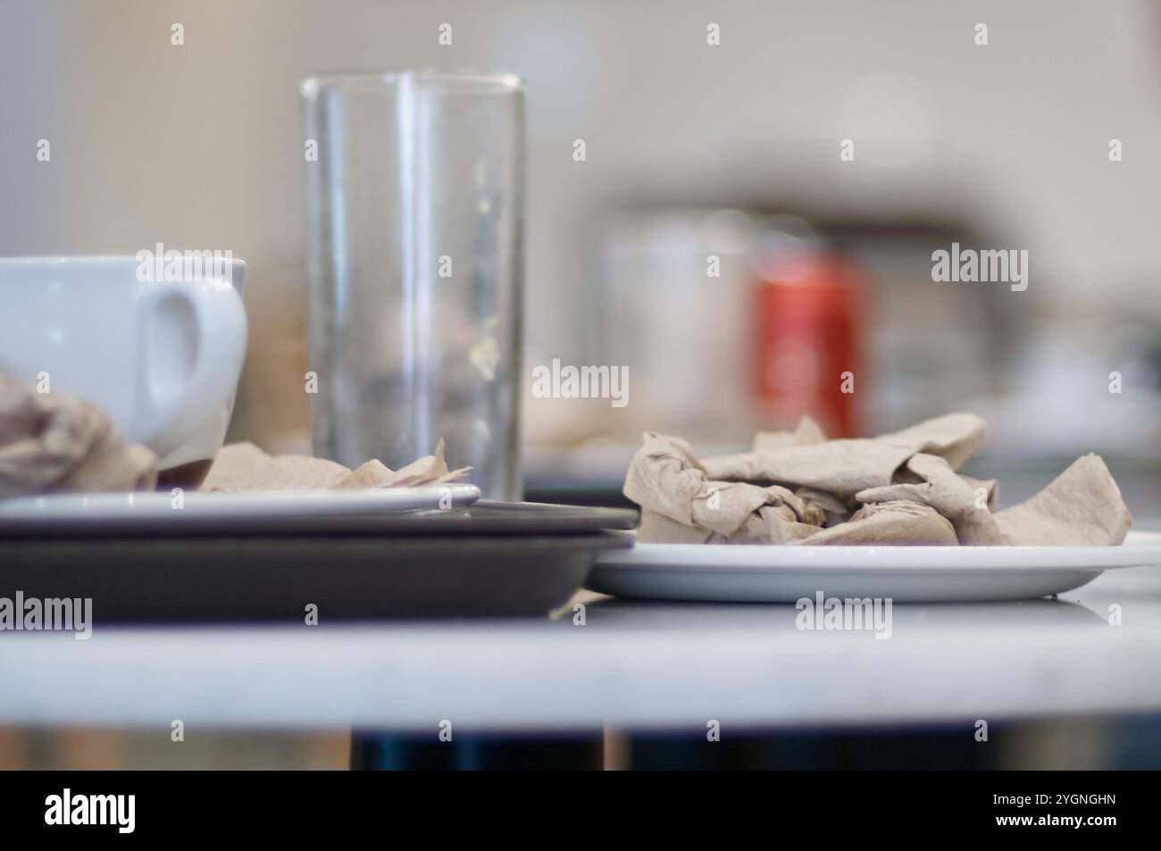 Empty cafe tables with leftover drinks and used cups, showcasing a ...
