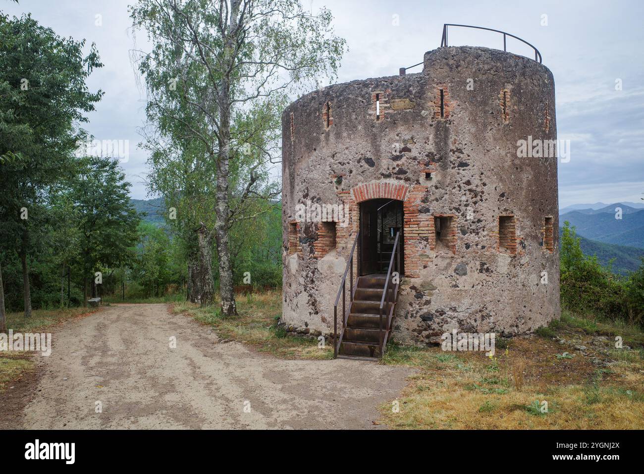 Olot, Spain - 7 Aug, 2024: Ruined lookout tower on edge of Crater del ...