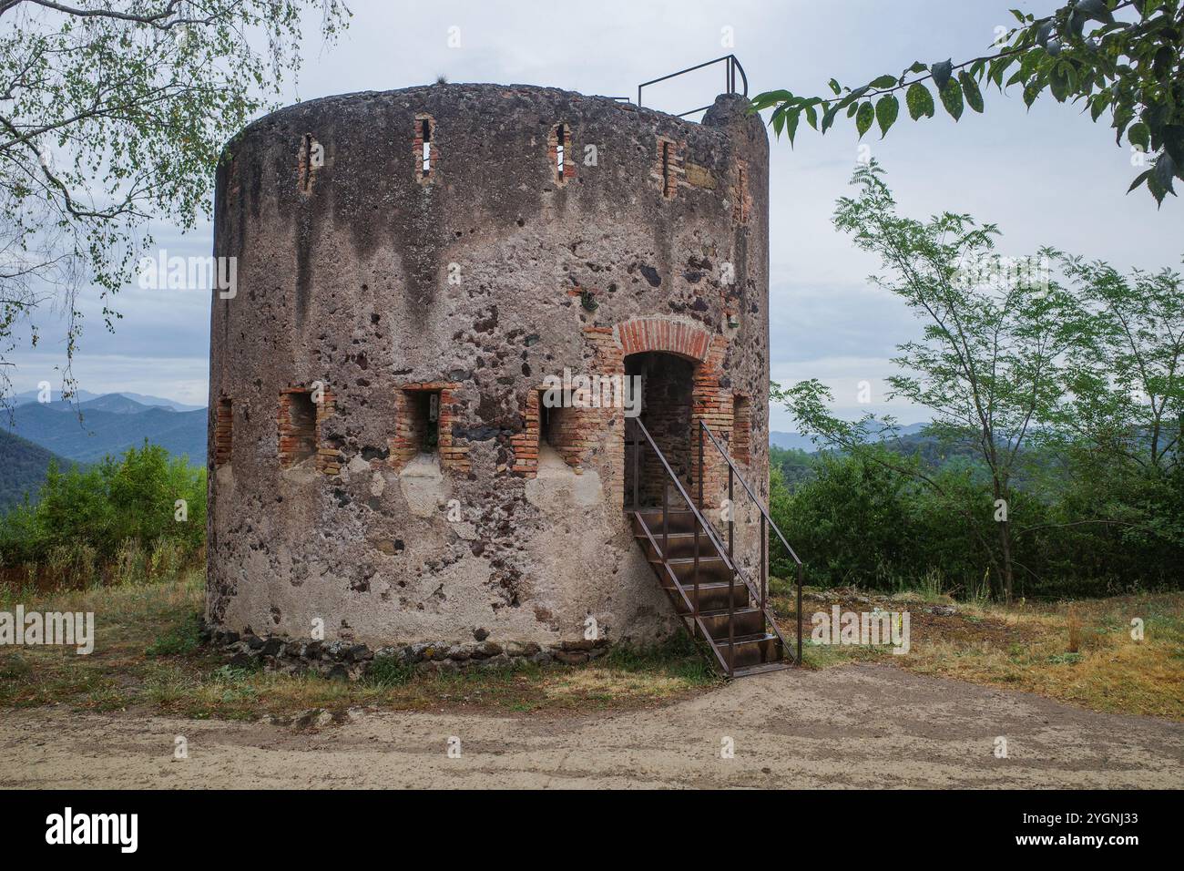 Olot, Spain - 7 Aug, 2024: Ruined lookout tower on edge of Crater del ...