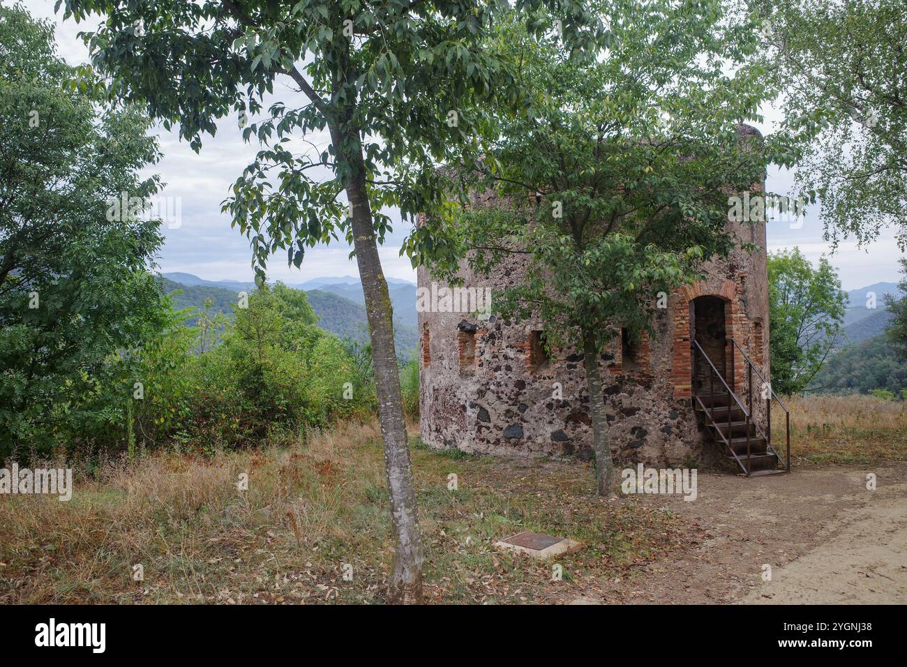 Olot, Spain - 7 Aug, 2024: Ruined lookout tower on edge of Crater del ...