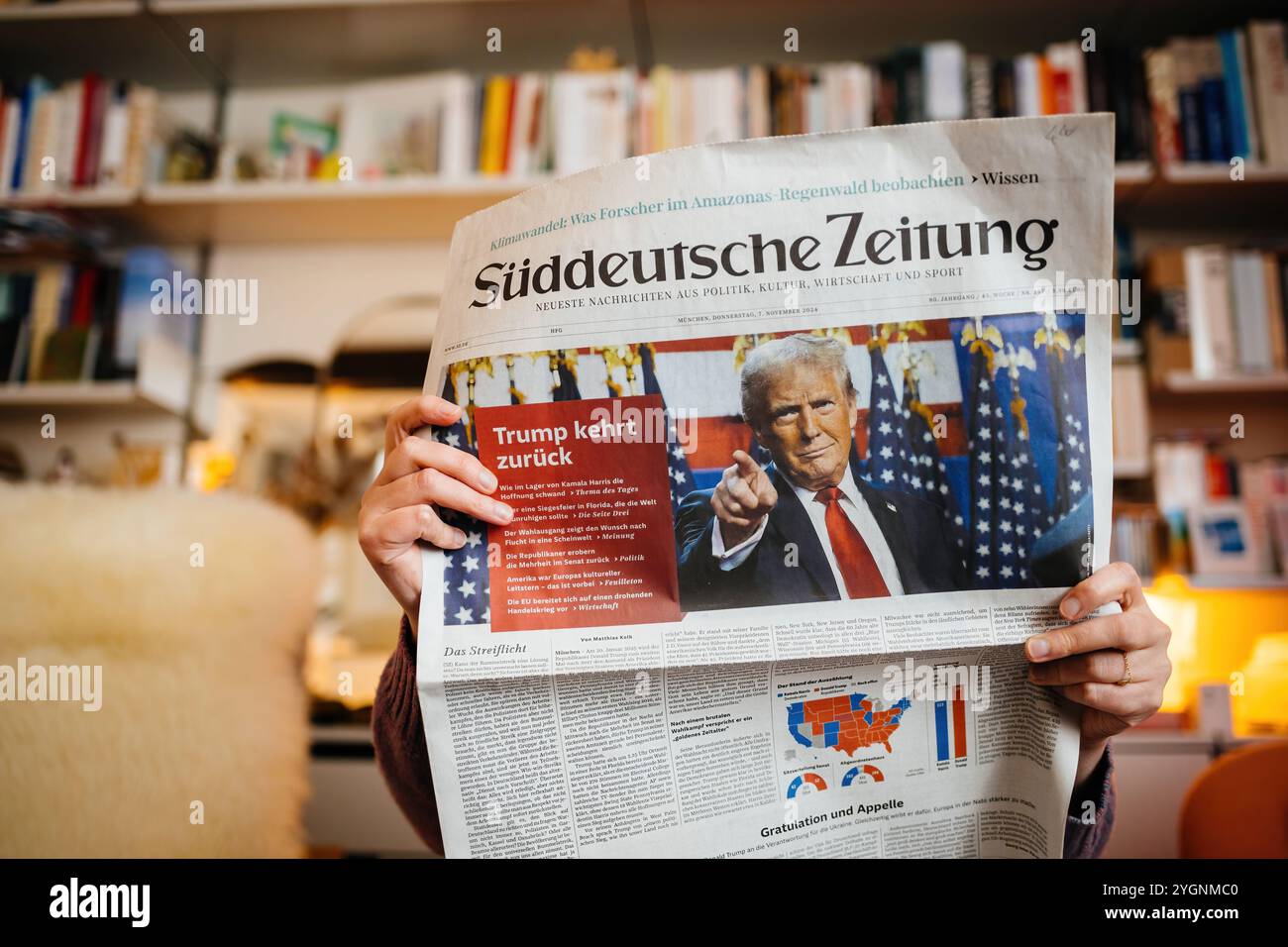 Paris, France - Nov 7, 2024: Woman reading German newspaper Suddeutsche ...