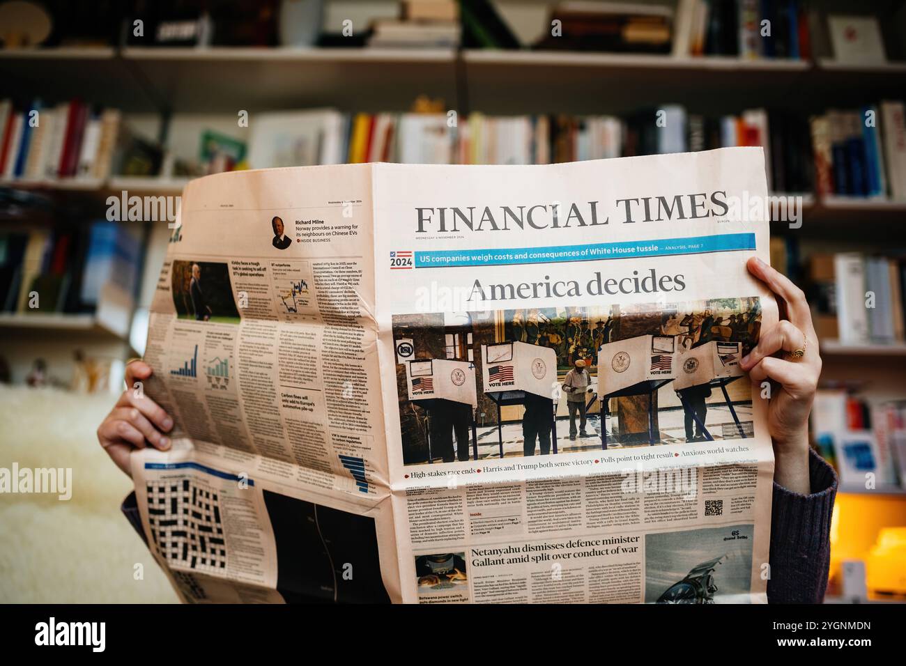 Paris, France - Nov 7, 2024: Person reading Financial Times in a cozy ...