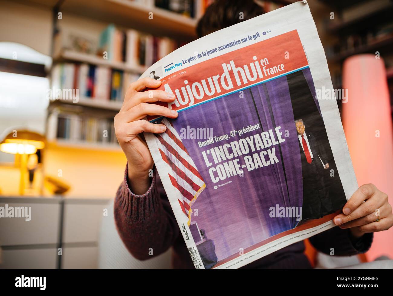 Paris, France - Nov 7, 2024: Person reading French newspaper Aujourd ...