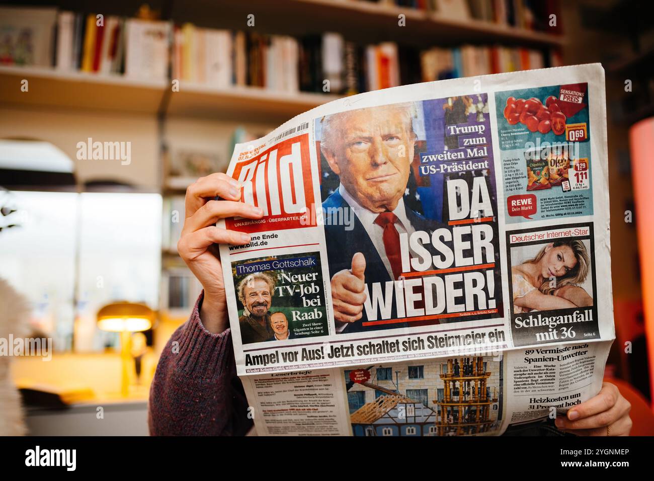 Paris, France - Nov 7, 2024: Person reading German tabloid Bild in a ...