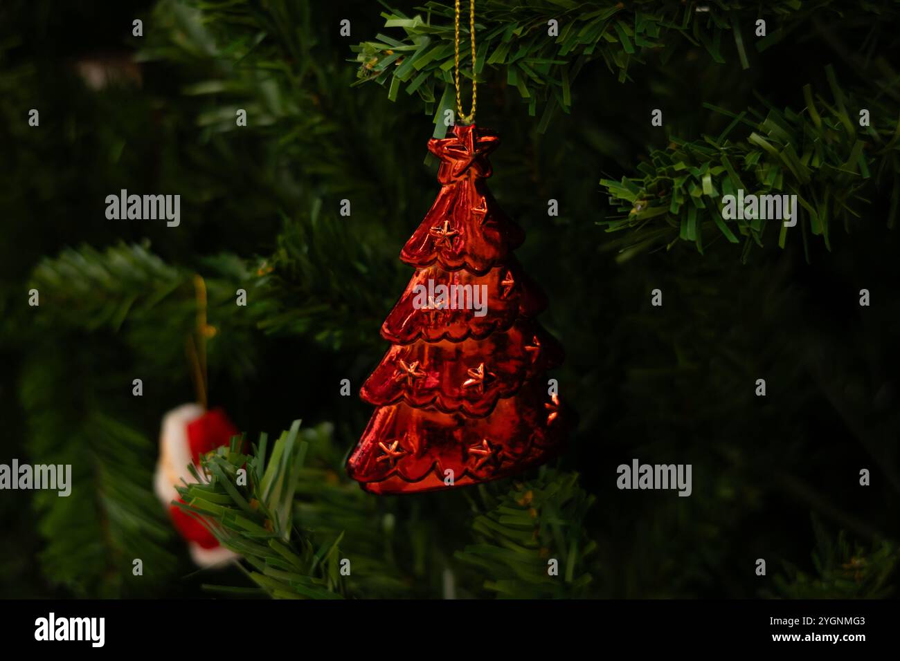 A golden red Christmas tree toy in the shape of a Christmas tree with a ...
