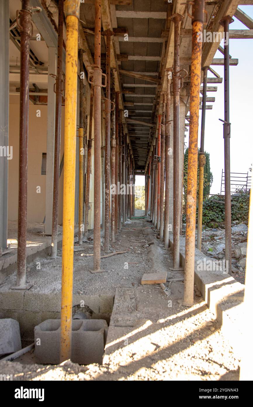 A construction site corridor supported by metal scaffolding, showing ...