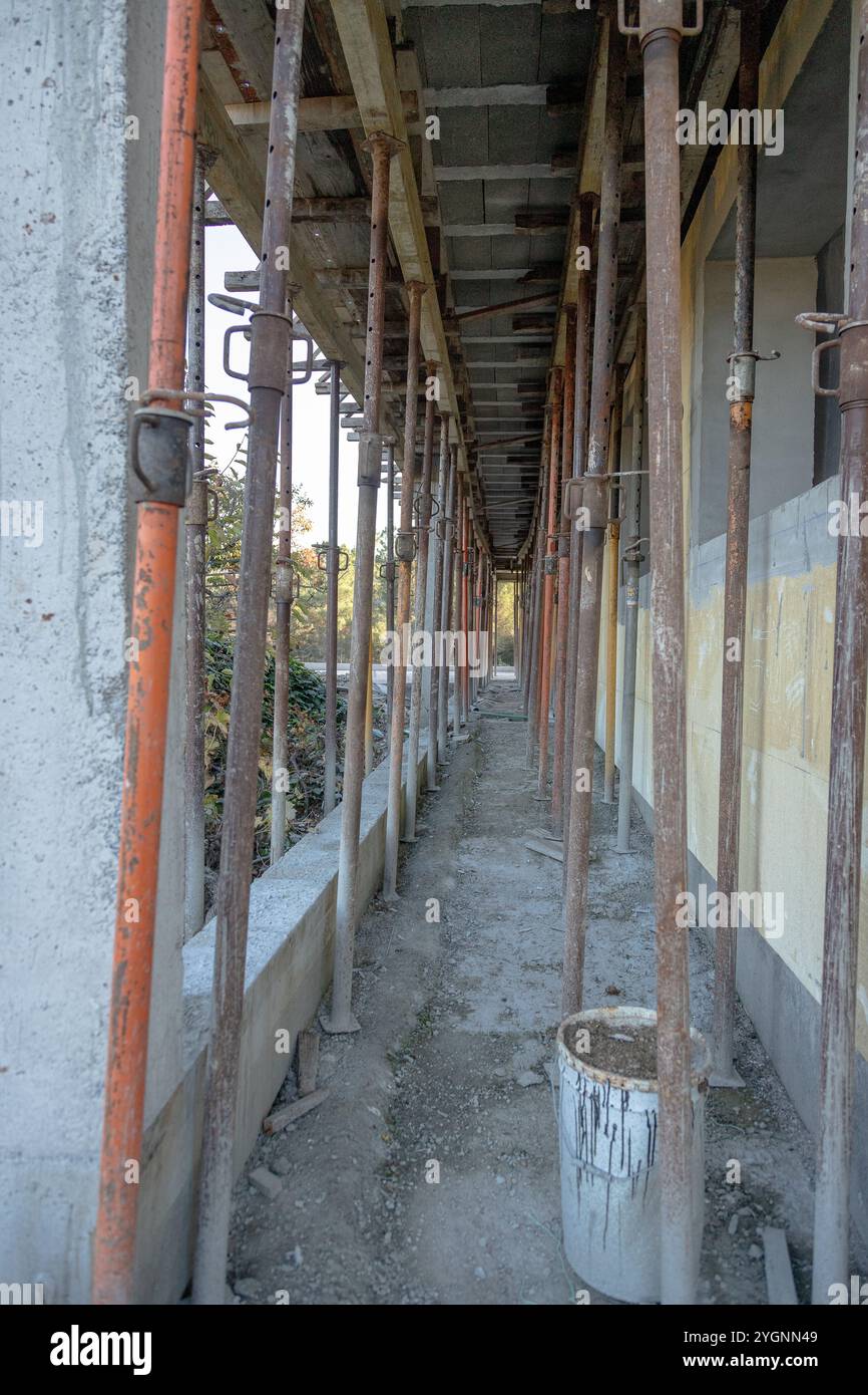 A construction site corridor supported by metal scaffolding, showing ...