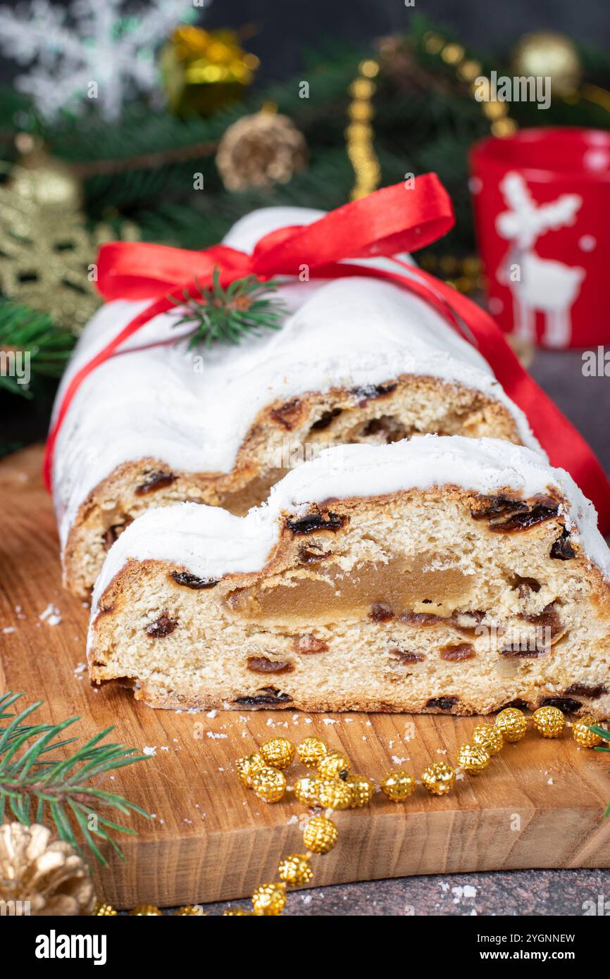 Christmas German Stollen with marzipan and dried fruits in powdered ...