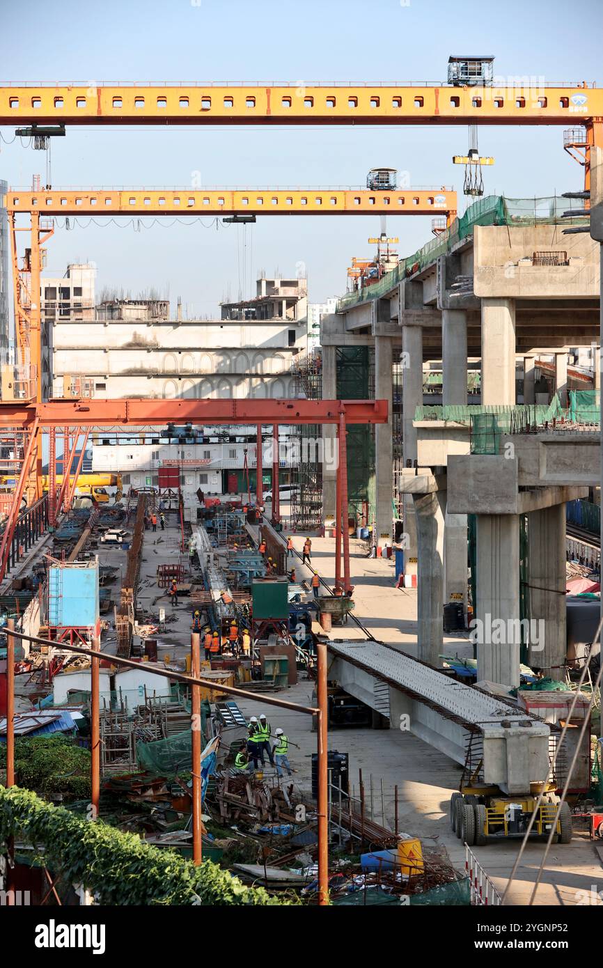 Dhaka, Bangladesh - November 08, 2024: Construction workers are working on the Moghbazar section ...