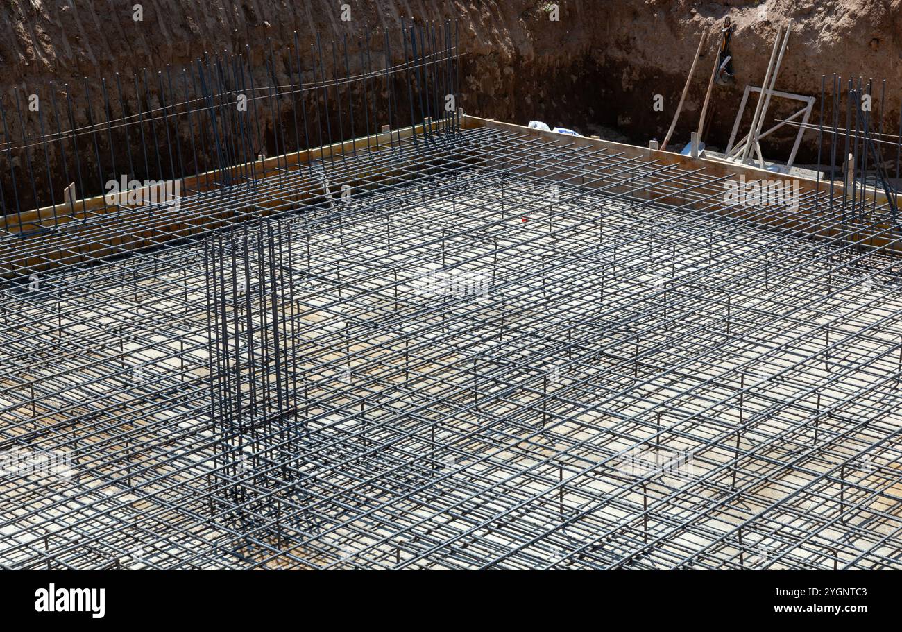 Steel reinforcement bars forming a grid structure for a building foundation at a construction ...