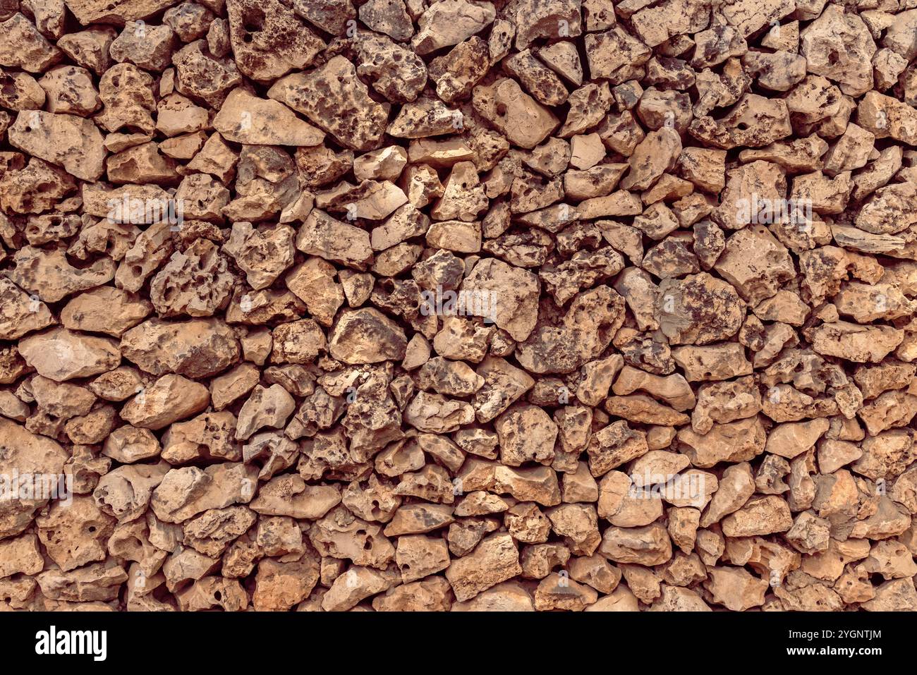 Stonewall a brown wall made of natural stones creates a rough texture ...