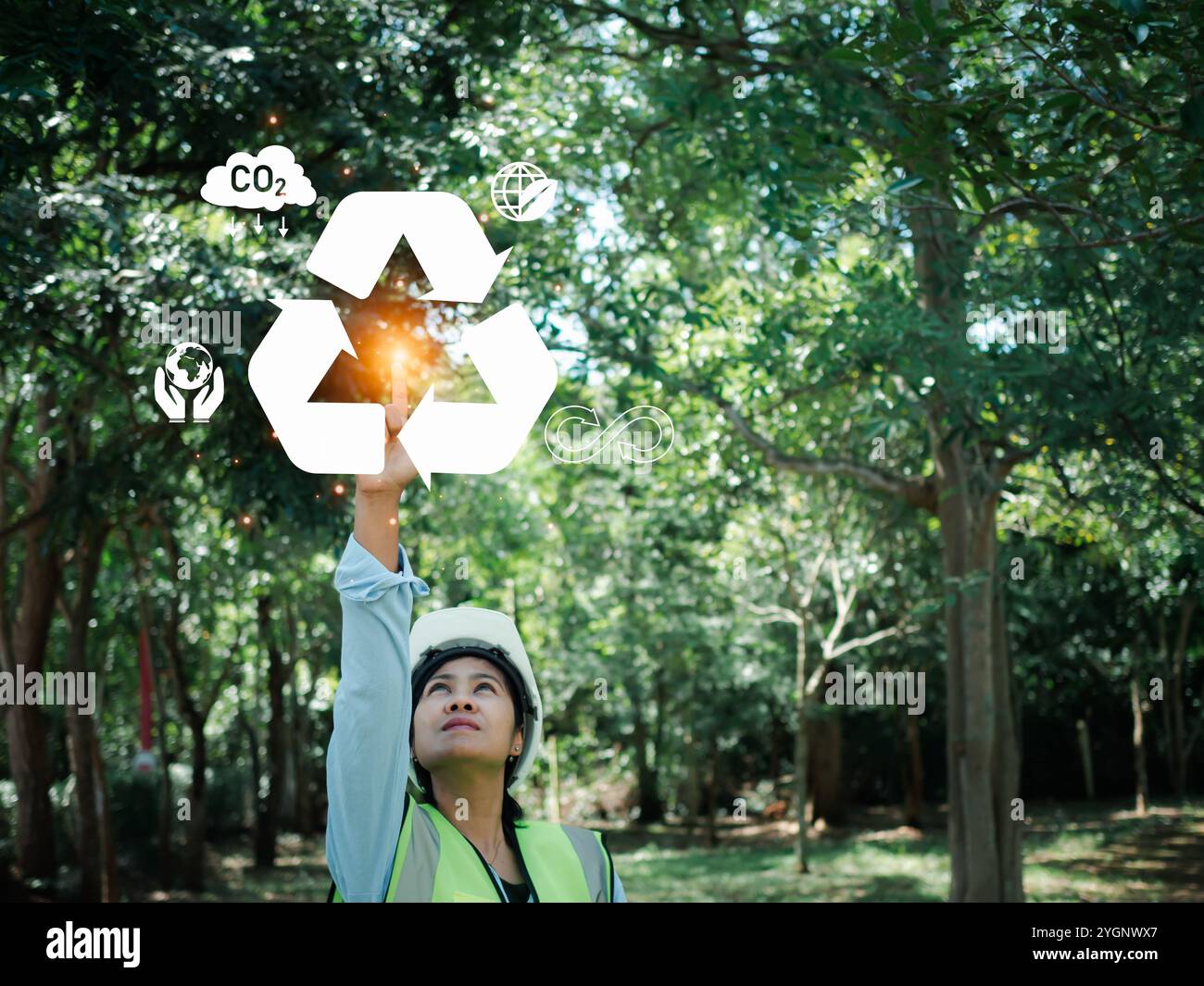 Woman engineer wearing a safety helmet show the symbol of recycling ...