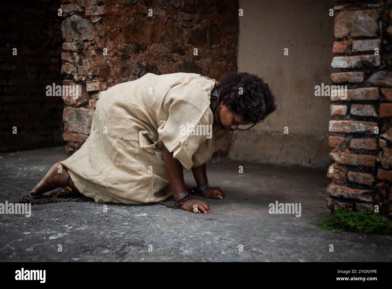 Portrait of a black woman in chains, with an iron mask over her mouth ...