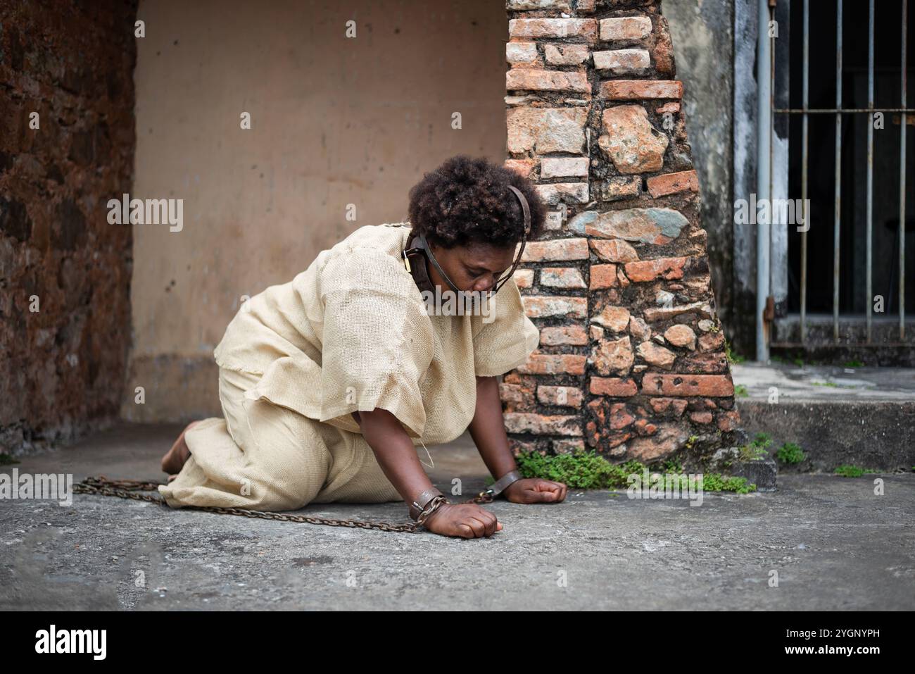 Portrait of a black woman in chains, with an iron mask over her mouth ...