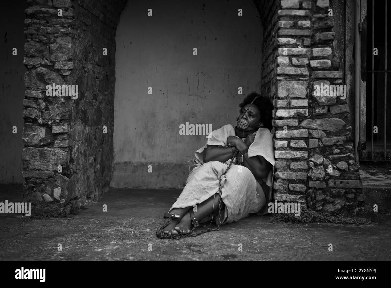 Black and white photo of a black woman with an iron mask over her mouth ...